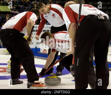 Team Canada's John Morris, right, and Nolan Thiessen sweep a rock as ...