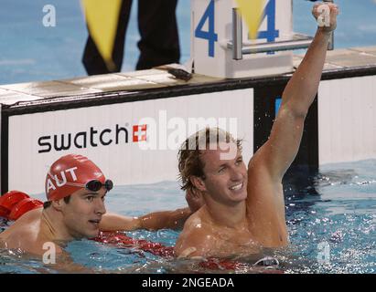 Markus Rogan, of Austria, right, and Aaron Peirsol, of the United ...