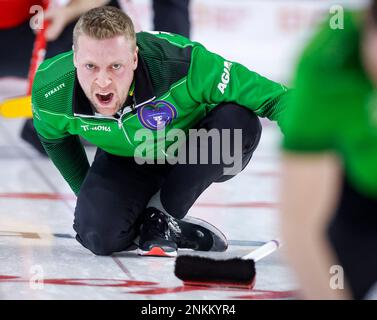 Team Saskatchewan skip Colton Flasch makes a shot while playing Team ...