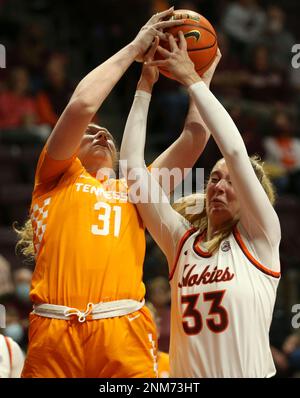 Virginia Tech's Elizabeth Kitley (33) shoots over Miami defenders ...