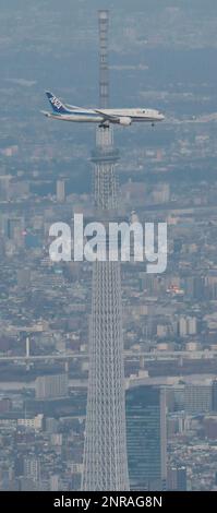 An airplane is flying over Tokyo Skytree in Sumida Ward on Feb.2, 2020 ...