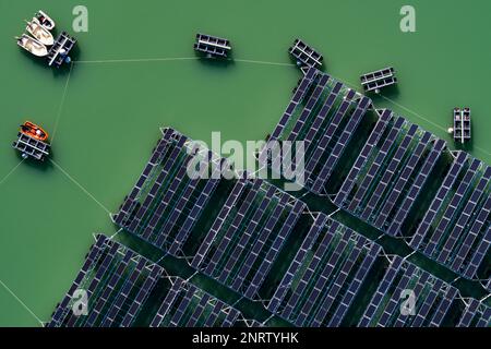 Floating barges with solar panels are pictured on the 'Lac des Toules ...