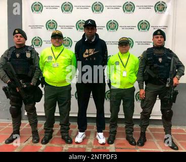 In this handout photo released by Colombia's Attorney General Press Office, police interview ...