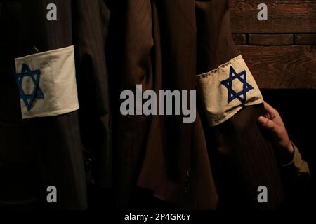 An Israeli officer looks at a jacket with a Star of David arm band at a ...