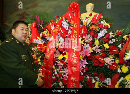Mao Xinyu, grandson of late Chinese leader Mao Zedong, and his wife Liu Bin (R), son Mao ...