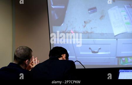Steven Spader, left, and attorney Andrew Winters look at an evidence ...