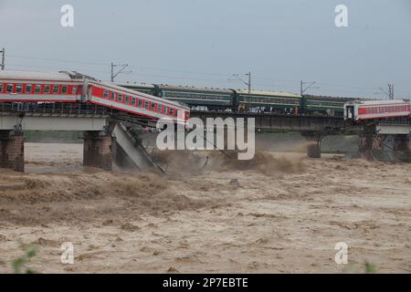 A train is seen derailed on a collapsed bridge at the Shiting River in ...