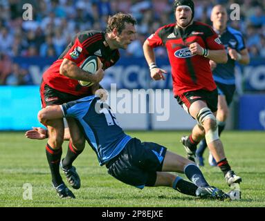 New Zealand Crusaders Adam Whitelock, left, runs with the ball as South ...