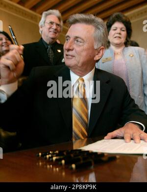 Arkansas Gov. Mike Beebe signs into law a 50 percent cut in the state ...