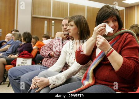 Cindy Sanderholm, right, her daughter Jennifer and husband Brian listen ...