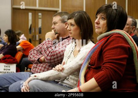 Cindy Sanderholm, right, her daughter Jennifer and husband Brian listen ...