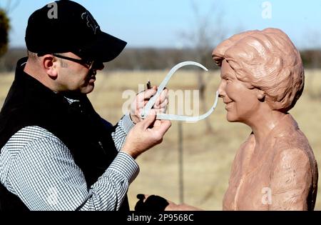 San Angelo, Tex. sculptor Scott Sustek checks a cutout of Laura Bush's ...