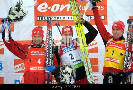 Norway's Ole Einar Bjorndalen, left, passes the finish line to win the ...
