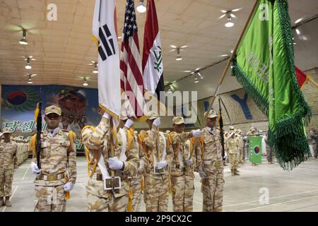 South Korean soldiers carry flags during a ceremony to mark the end of ...
