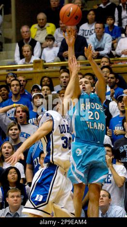 Rhode Island's Jimmy Baron (20) drives to the hoop over Dayton's Kurt ...