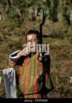 Bhutan's fifth King Jigme Khesar Namgyal Wangchuk adjusts his robe ...
