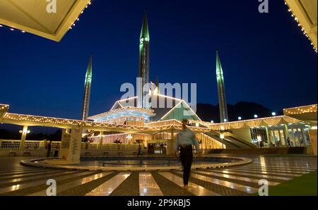 A Pakistani police officer walks in front of Islamabad's grand Faisal ...