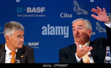 BASF CEO Juergen Hambrecht, left, and Armin Meyer, chairman of the board of Ciba, inform the ...