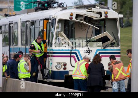 Police and transit workers investigate the scene of a Light Rapid ...