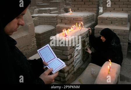 Relatives light candles and recite verses of the Holy Quran as they pay ...