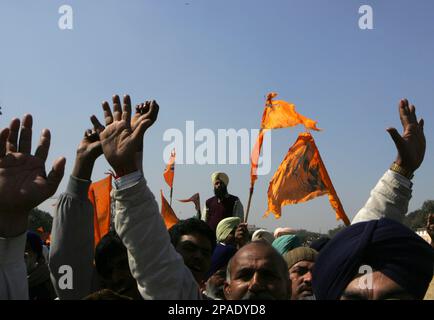 Supporters of Shiromani Akali Dal raise slogans as they listen to a ...
