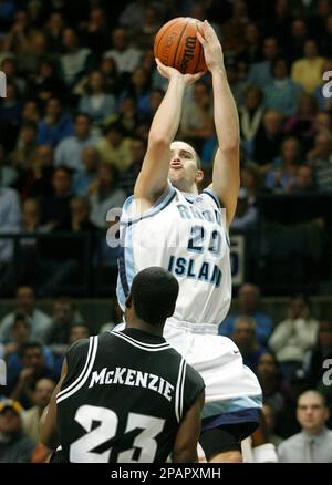 Rhode Island's Jimmy Baron (20) drives to the hoop over Dayton's Kurt ...