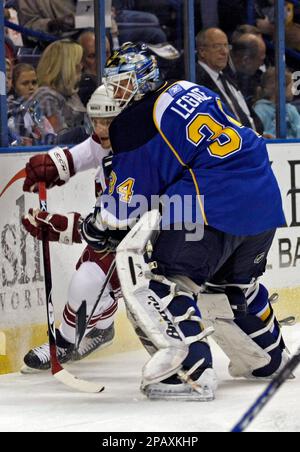 St. Louis Blues goaltender Manny Legace lets a shot by Minnesota Wild's ...
