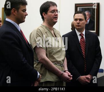 Flanked by defense attorneys Michael Kielty, left, and Ethan Corlija ...