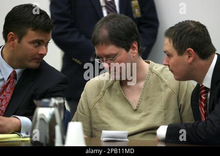 Flanked by defense attorneys Michael Kielty, left, and Ethan Corlija ...