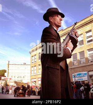 A man dressed as notorious gangster Al Brady lies in the street after ...