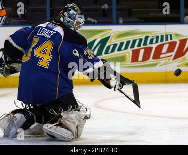 St. Louis Blues goaltender Manny Legace lets a shot by Minnesota Wild's ...