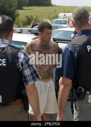 Law enforcement officials talk to inmate Jerry Martin, 37, just after ...