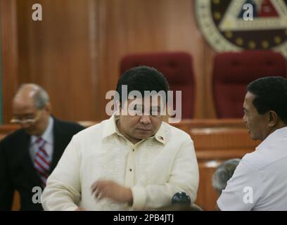 Philippine Senator Jinggoy Estrada, center, the son and co-accused of ...