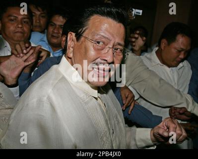 Philippine Senator Jinggoy Estrada, center, the son and co-accused of ousted President Joseph ...