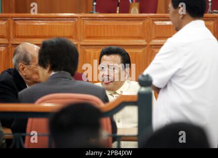 Philippine Senator Jinggoy Estrada, center, the son and co-accused of ousted President Joseph ...