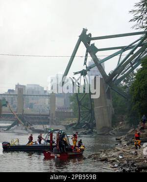 Emergency personnel respond at the scene of a freeway bridge collapse ...