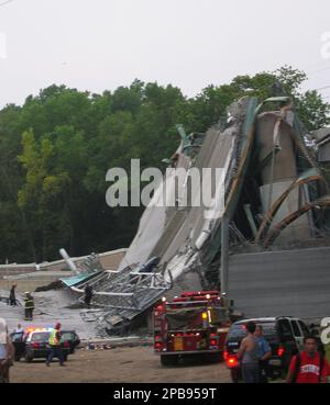 Emergency personnel respond at the scene of a freeway bridge collapse ...