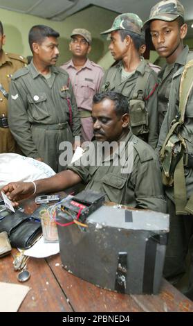 Sri Lankan government soldiers inspect the identity of commuters at a check point in Colombo ...