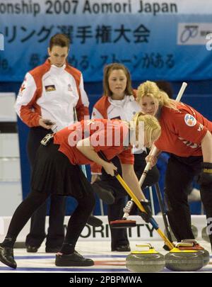 Canada's skip Kelly Scott at right reacts near her teammates and coach ...