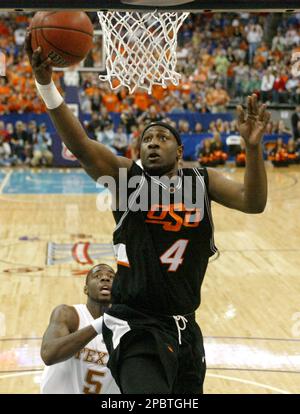 Oklahoma State forward Mario Boggan, left, deflects a shot by Mercer ...