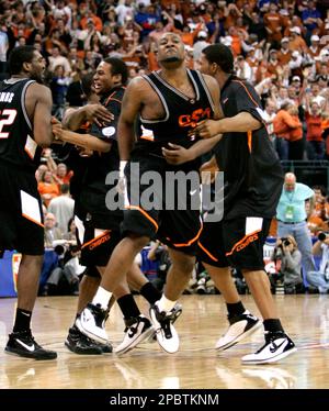 Oklahoma State forward Mario Boggan, left, deflects a shot by Mercer ...