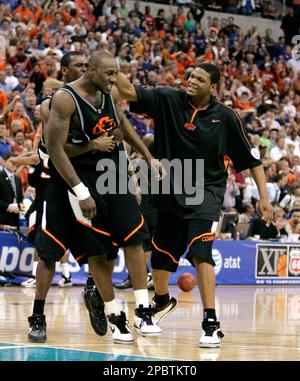 Oklahoma State forward Mario Boggan, left, deflects a shot by Mercer ...