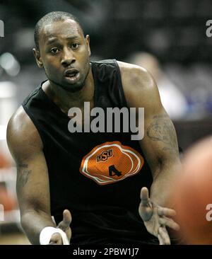 Oklahoma State forward Mario Boggan, left, deflects a shot by Mercer ...