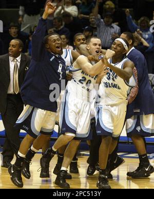 Rhode Island's Jimmy Baron (20) drives to the hoop over Dayton's Kurt ...
