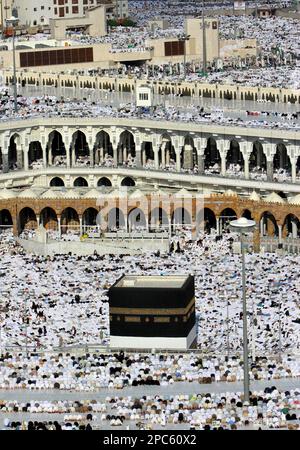 Tens of thousands of Muslim pilgrims attend night prayers around the ...