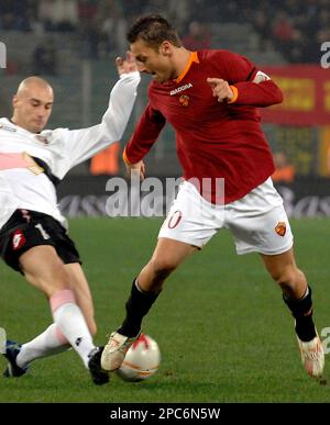Roma's Francesco Totti, right, dribbles between Juventus' Mauro German ...