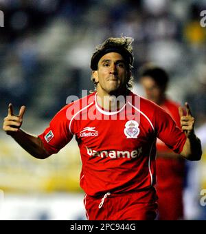 Toluca's soccer player Bruno Marioni, top, from Argentina kicks the ...