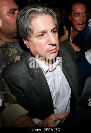 Former Lebanese President Amin Gemayel mourns over the coffin of his ...