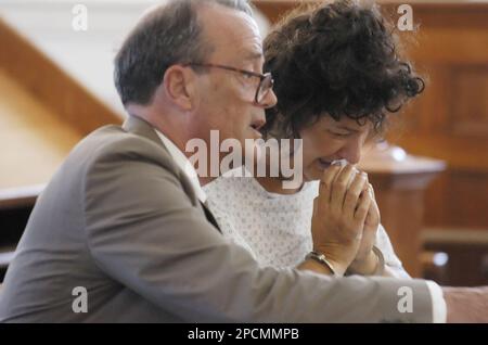 Louise Desnoyers, 48, of Montreal, Canada, cries quietly after being ...