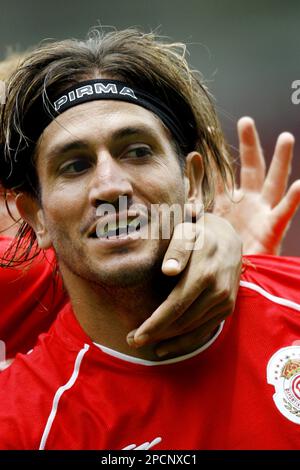 Toluca's soccer player Bruno Marioni, top, from Argentina kicks the ...